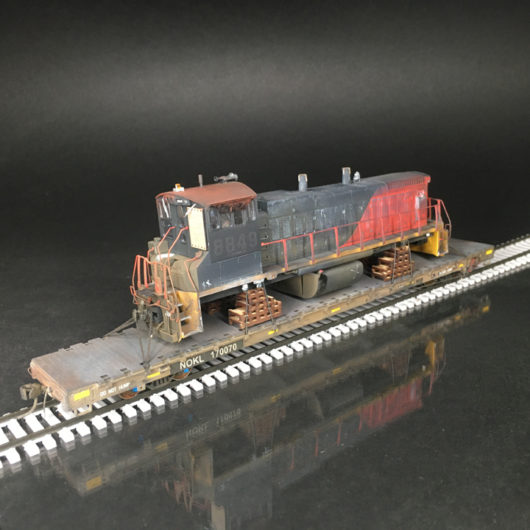 Atlas HO scale flatcar with MP15DC loco -Protoloads