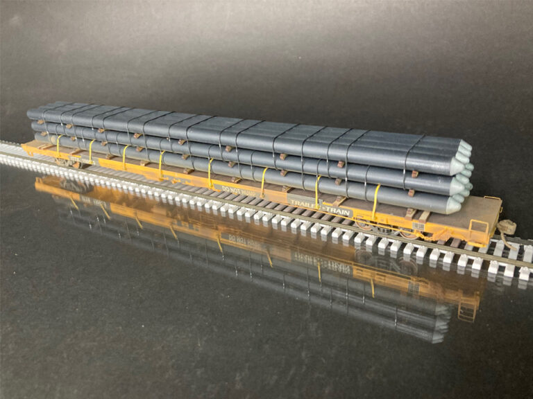HO Scale 89’ Flatcar with Piles -Protoloads